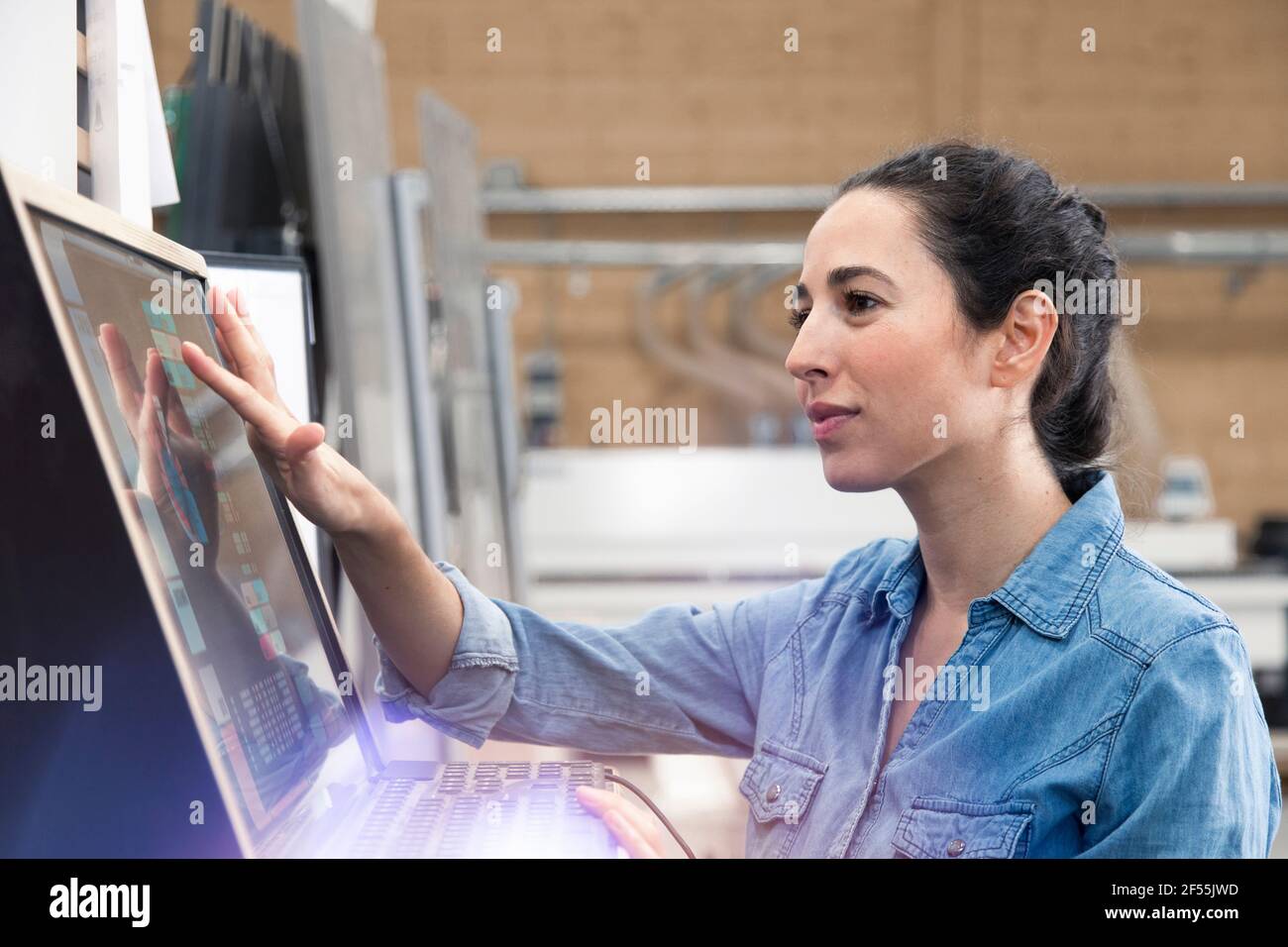Businesswoman operating control panel screen in factory Stock Photo - Alamy