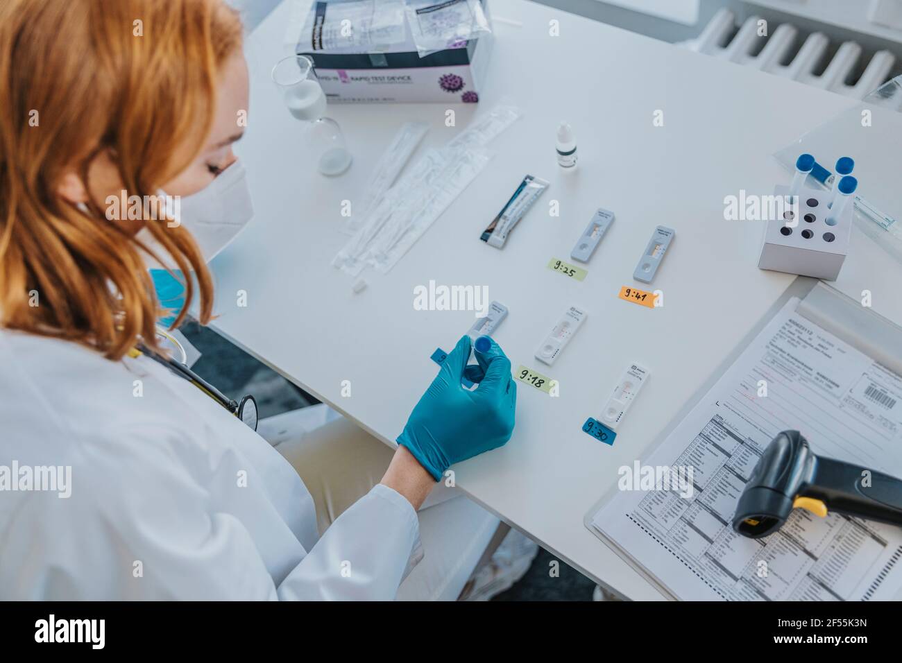 Expertise checking medical sample on test cassettes at examination room ...