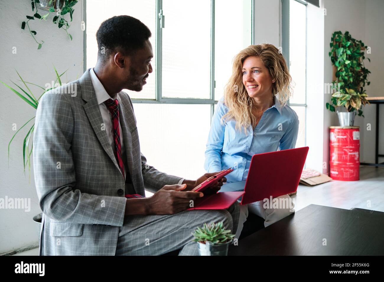 Business professionals talking to each other Stock Photo - Alamy