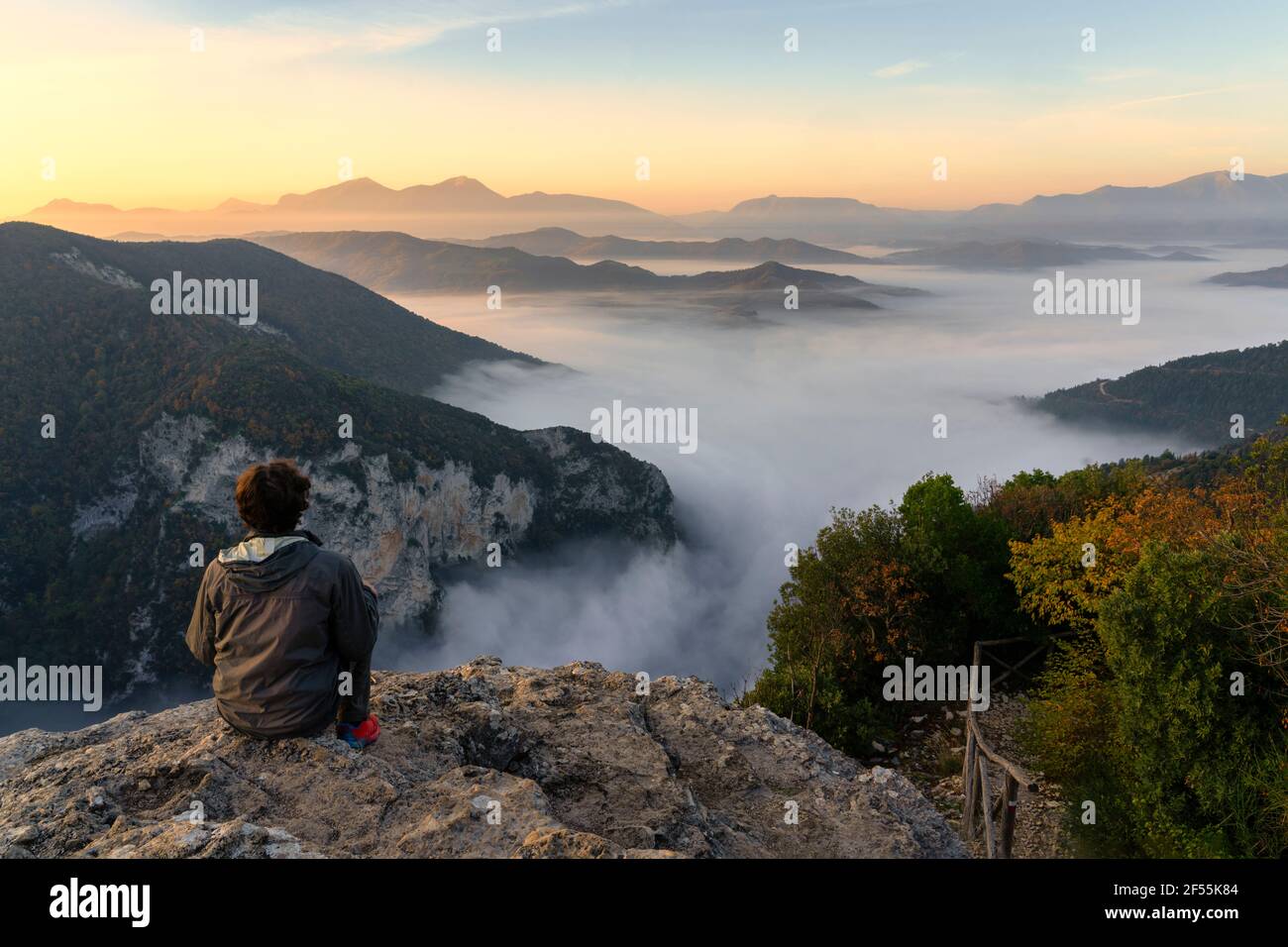 Male tourist sitting cliff watching sunrise furlo gorge hi-res stock ...