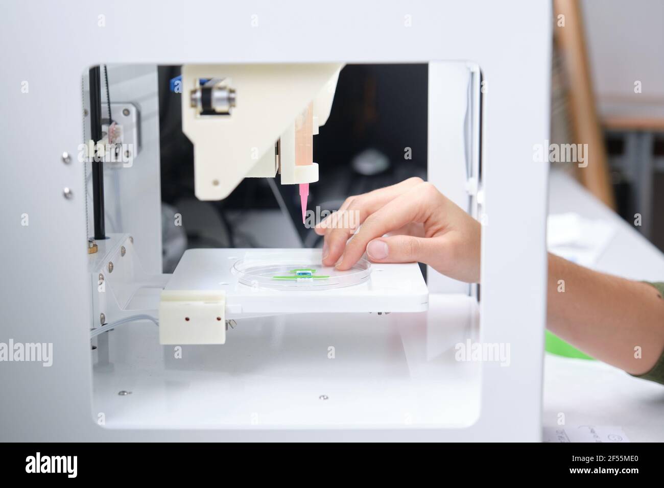 Researcher getting 3D bioprinter ready to 3D print cells onto an ...