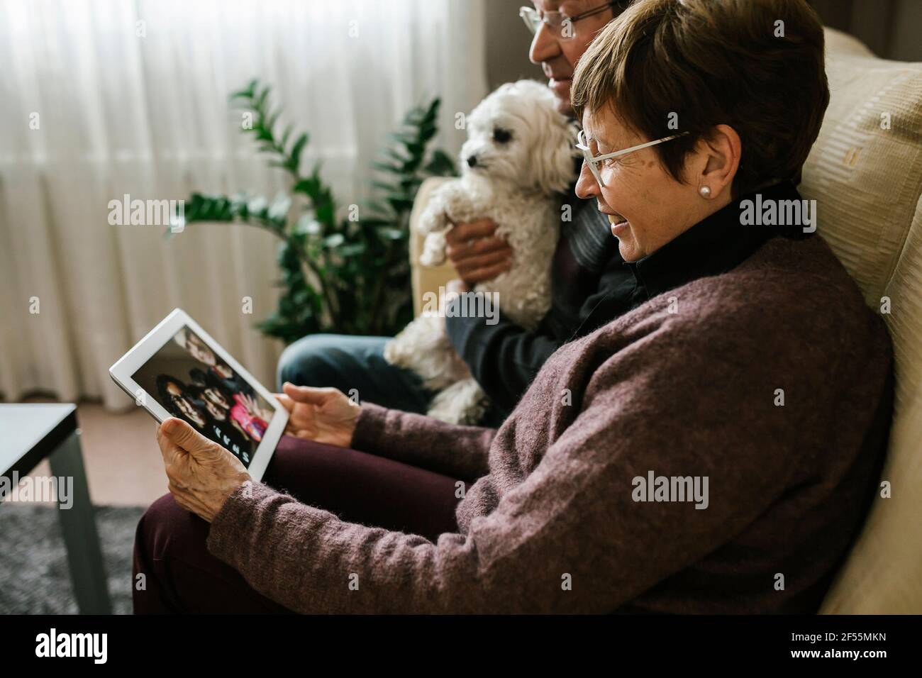 Grandparents on video call with family through tablet at home Stock ...