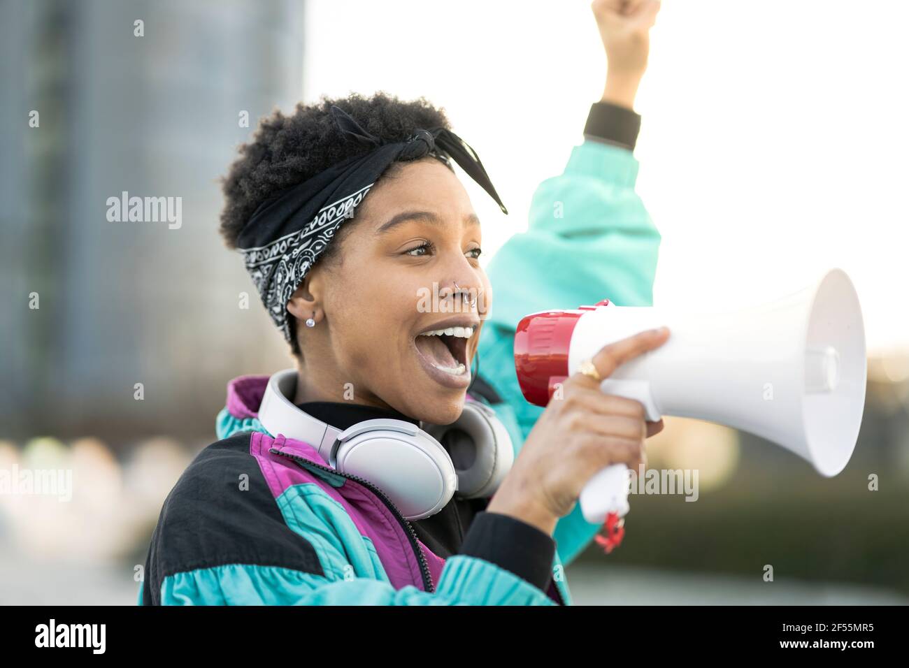 Young woman doing announcement through megaphone Stock Photo - Alamy