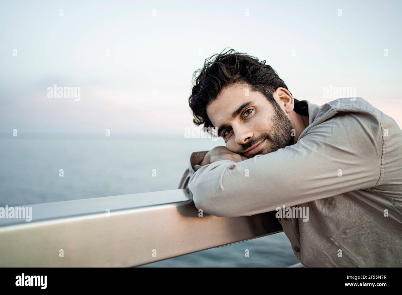 Man leaning against railing hi-res stock photography and images - Alamy