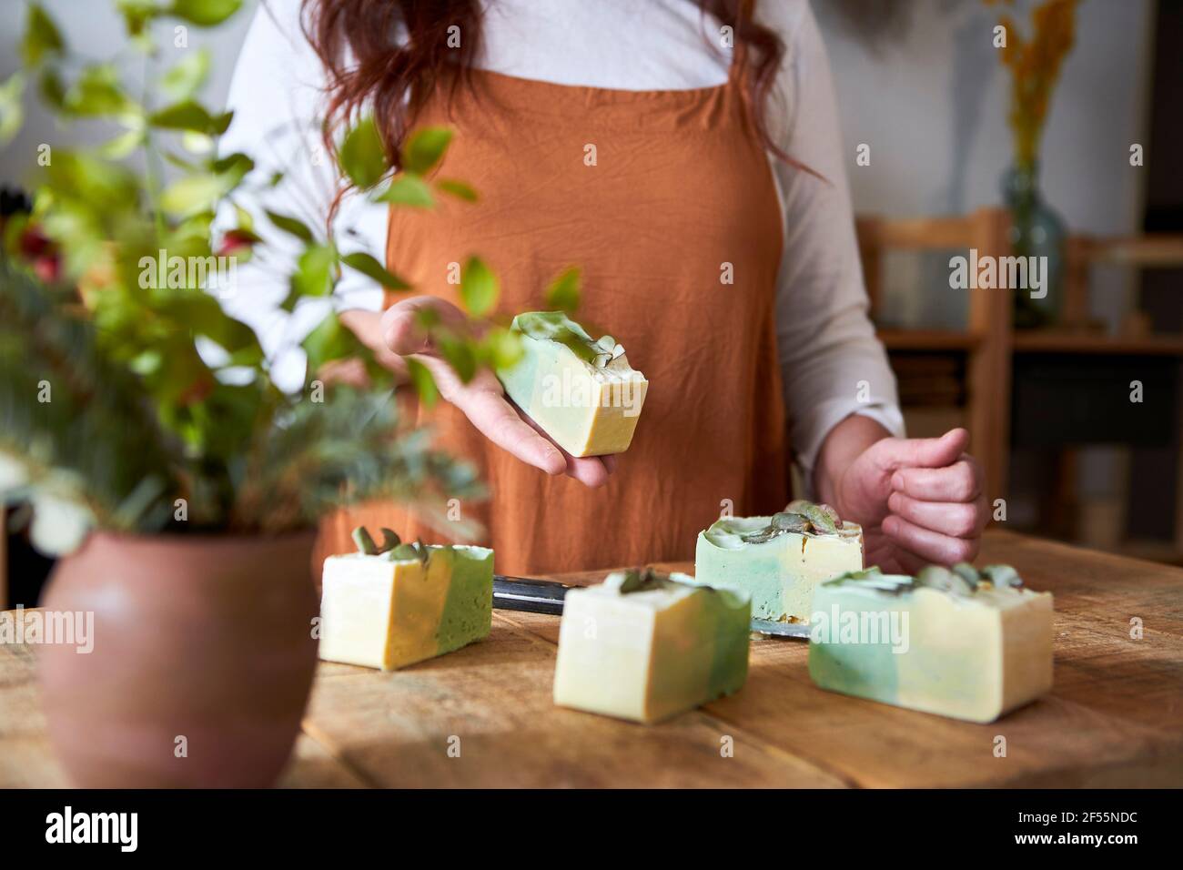 Woman showing bar of soap at workshop Stock Photo - Alamy