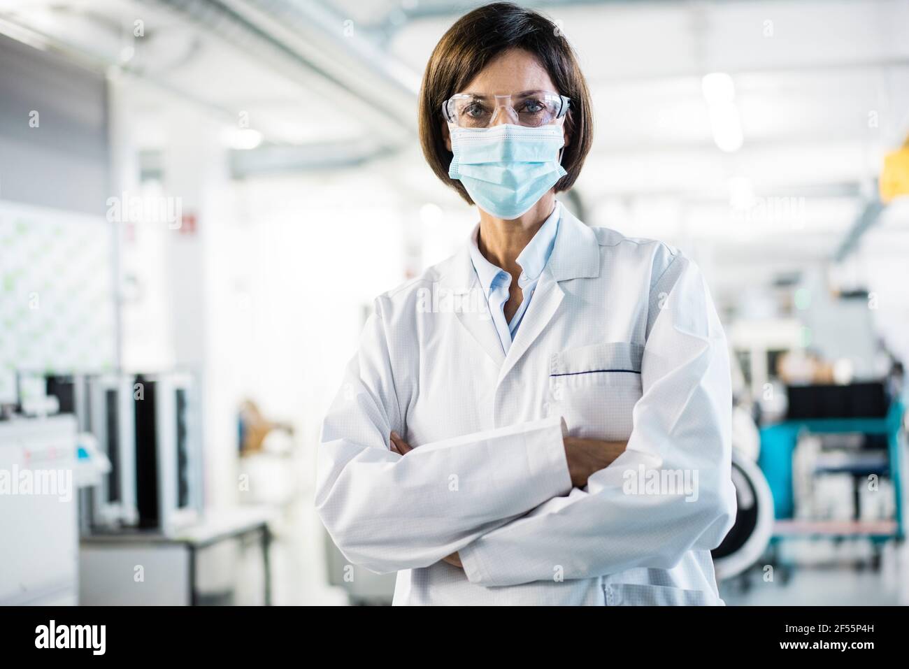 Female scientist with arms crossed at laboratory during pandemic Stock Photo - Alamy