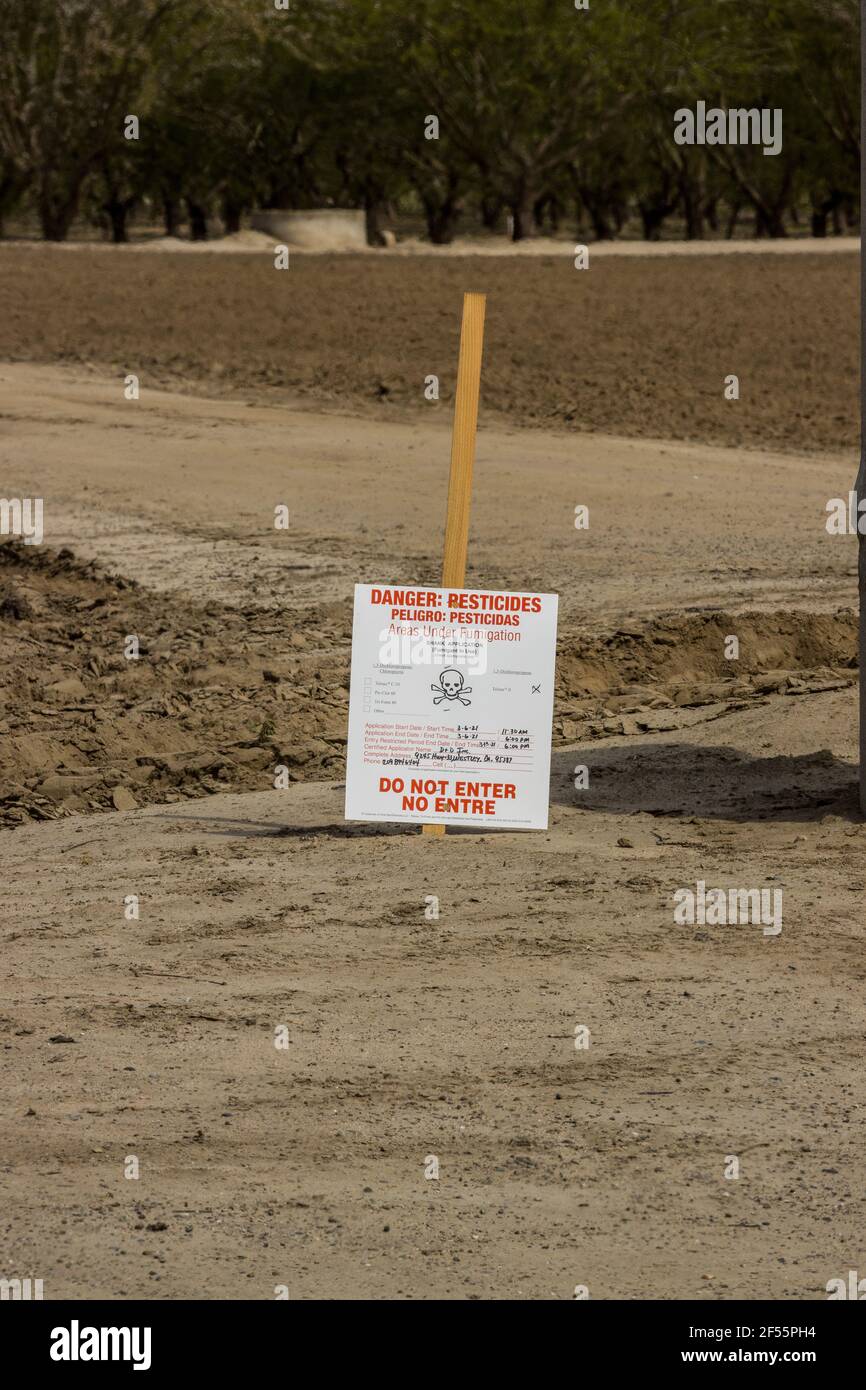 A sign warning of the application of pesticide fumigant on what was an ...