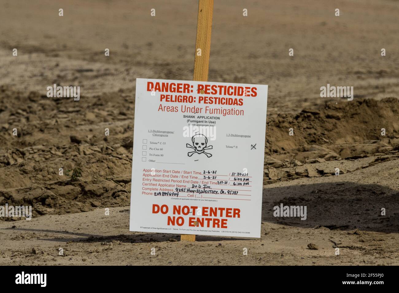 A sign warning of the application of pesticide fumigant on what was an ...