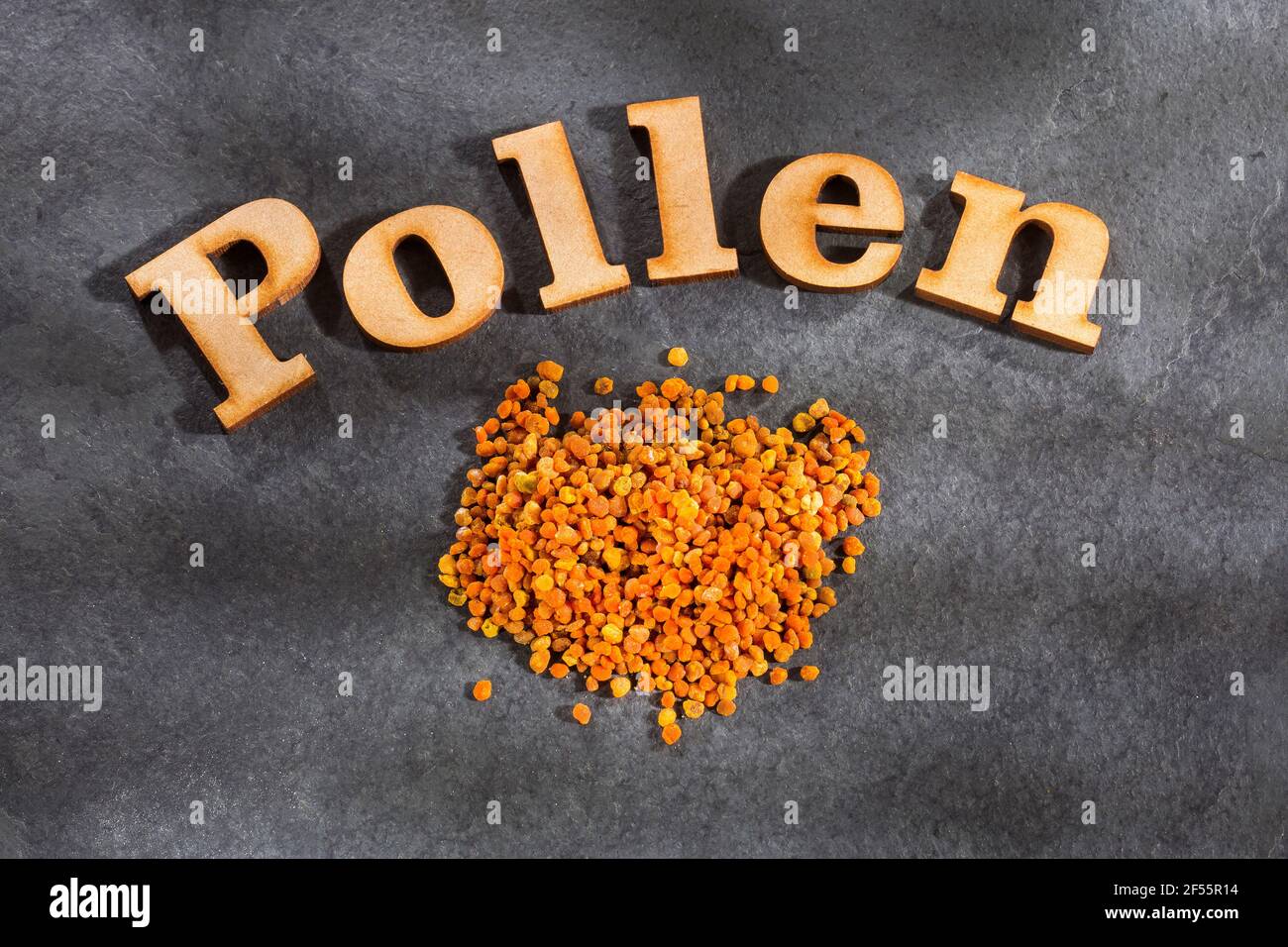 Pollen phrase in wooden letters - Bee pollen grains Stock Photo - Alamy
