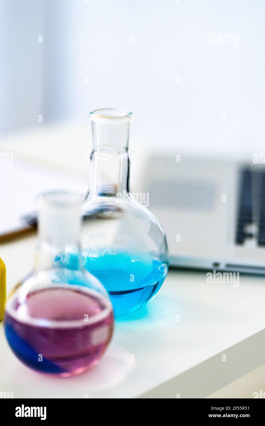 Beakers with chemical solution on table in chemistry lab Stock Photo ...