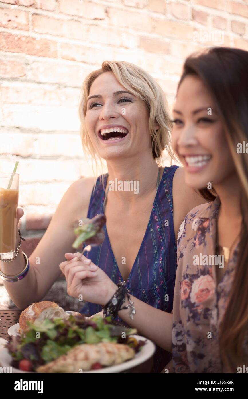Female friends enjoying lunch in restaurant Stock Photo - Alamy