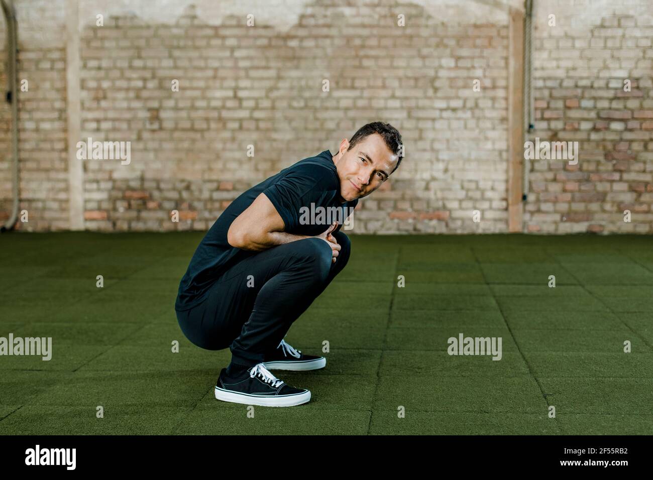 Man squatting gym hi-res stock photography and images - Alamy