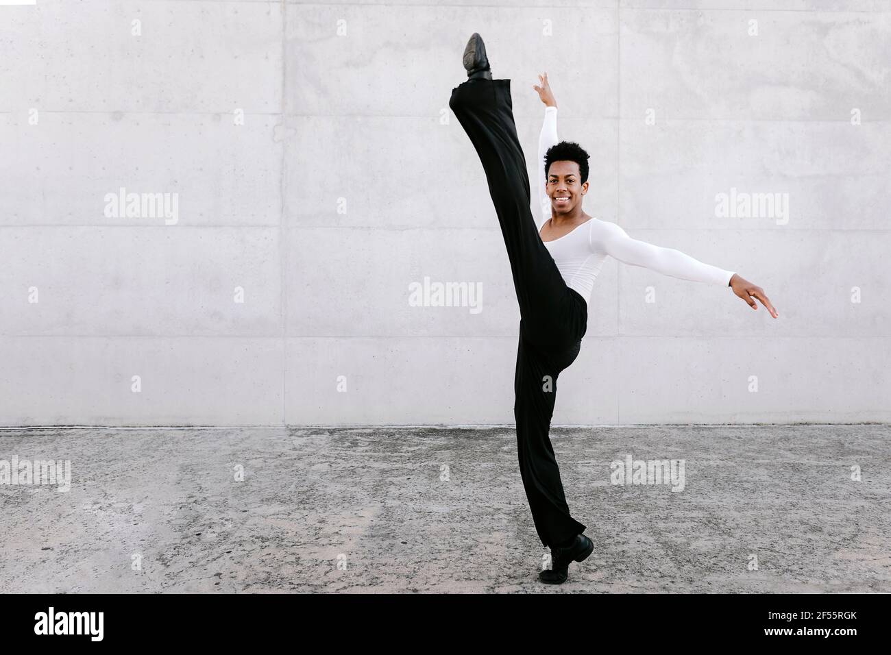 Flexible male dancer practicing against wall Stock Photo - Alamy