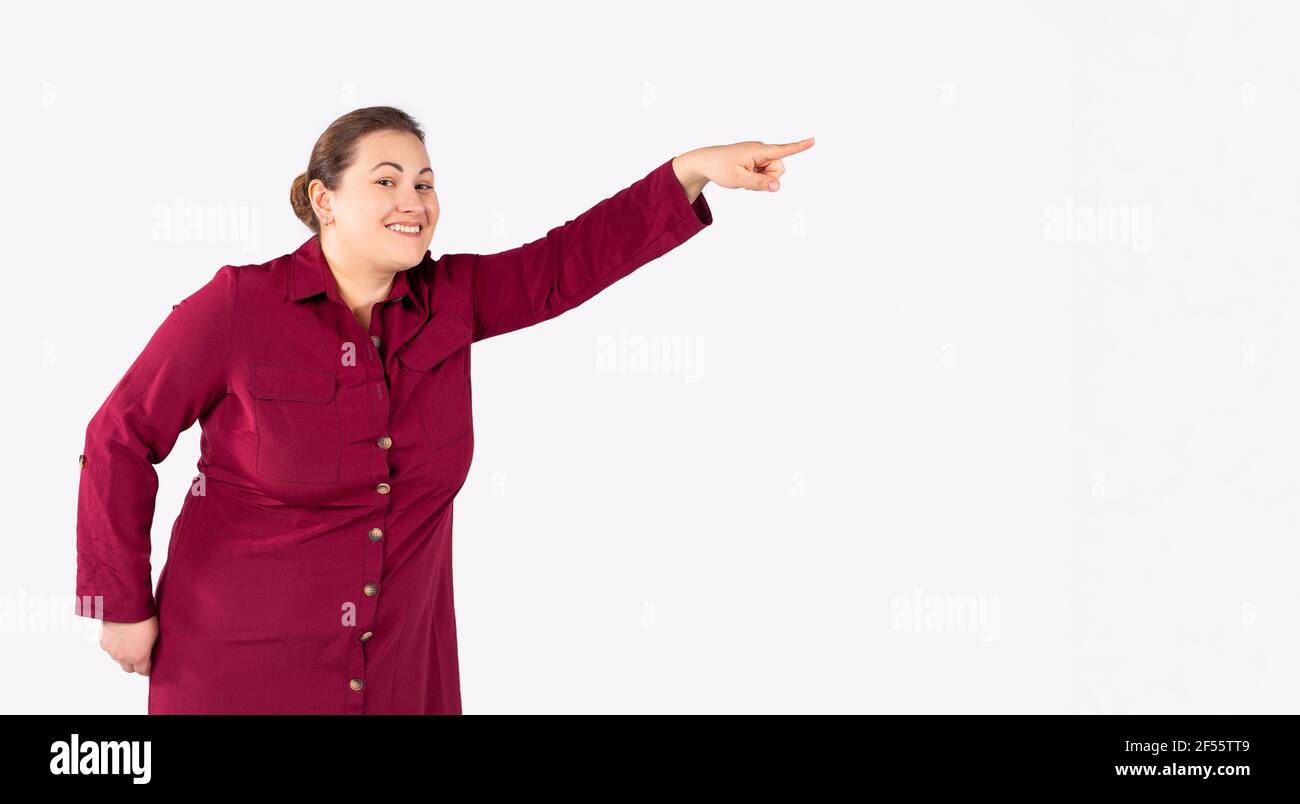 Half length shot of optimistic young caucasian large woman pointing ...