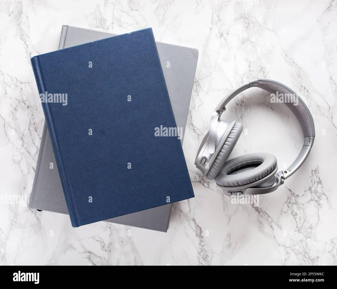 audiobook concept modern wireless headphones and book Stock Photo - Alamy
