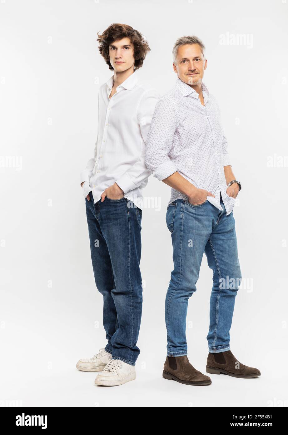 Father standing by son against white background Stock Photo - Alamy