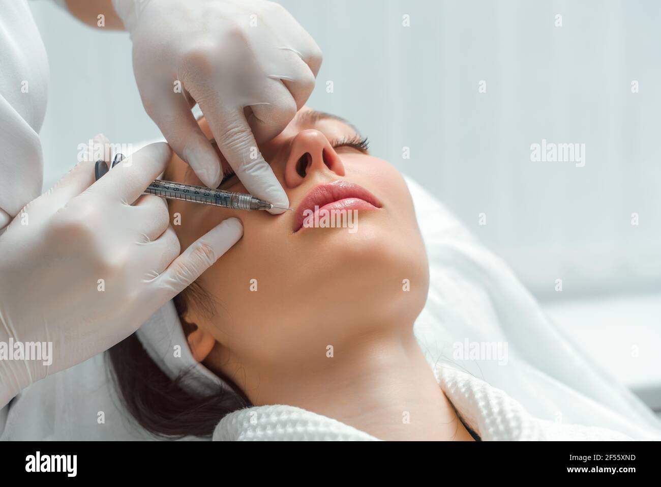 Lip augmentation and correction procedure in a cosmetology salon. The ...