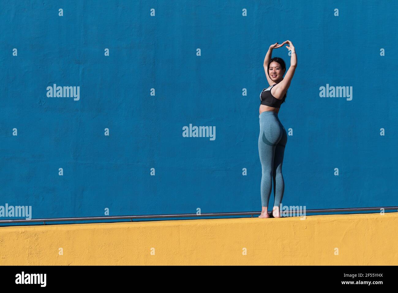 Woman standing wall posture hi-res stock photography and images - Alamy