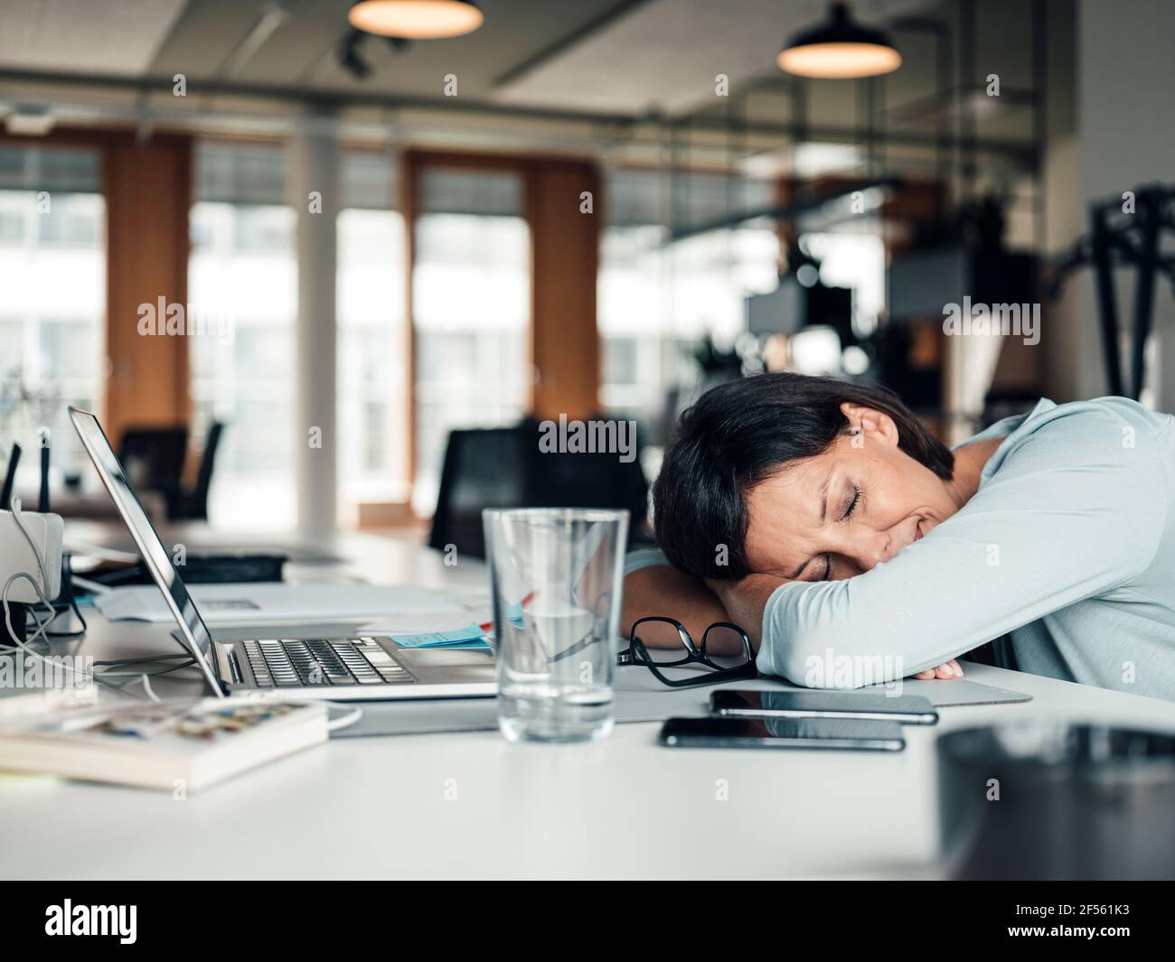 Woman with head down on desk hi-res stock photography and images - Alamy