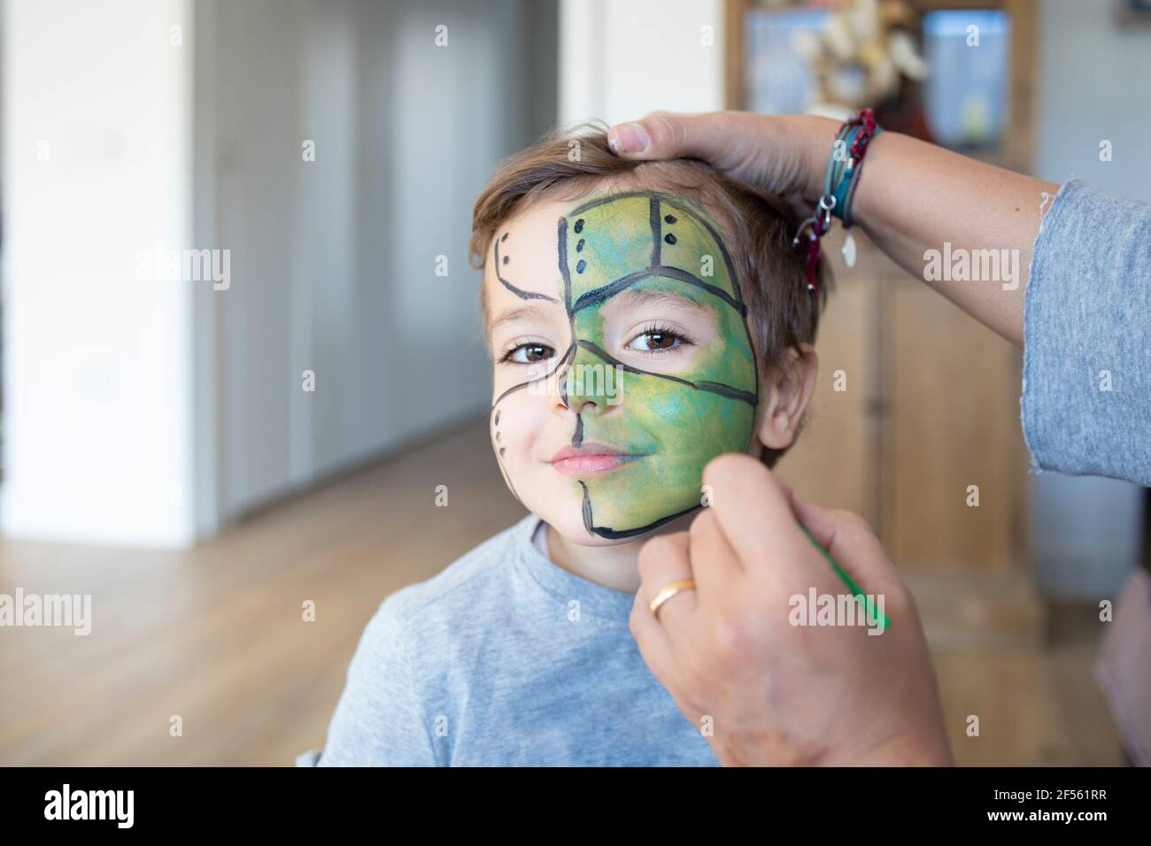 Child painted hand face hi-res stock photography and images - Alamy
