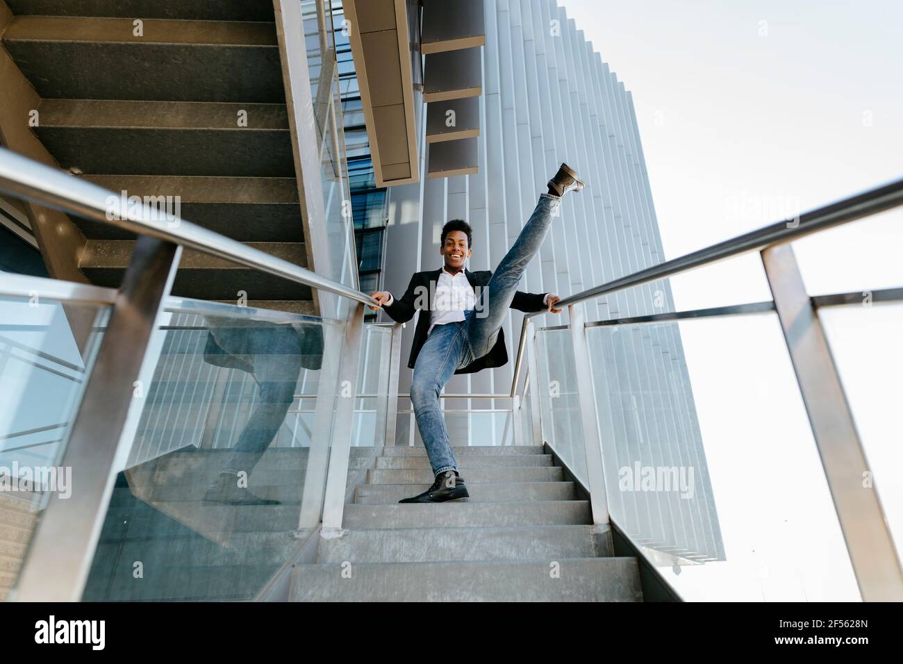 Male professional dancing while standing on one leg at staircase Stock ...