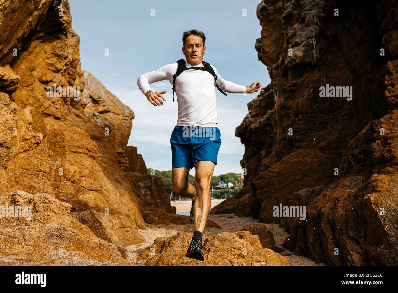 Man jumping over rocks hi-res stock photography and images - Alamy