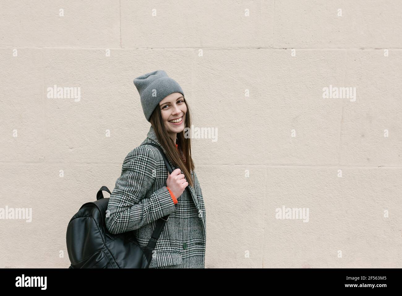 Woman holding her backpack hi-res stock photography and images - Alamy