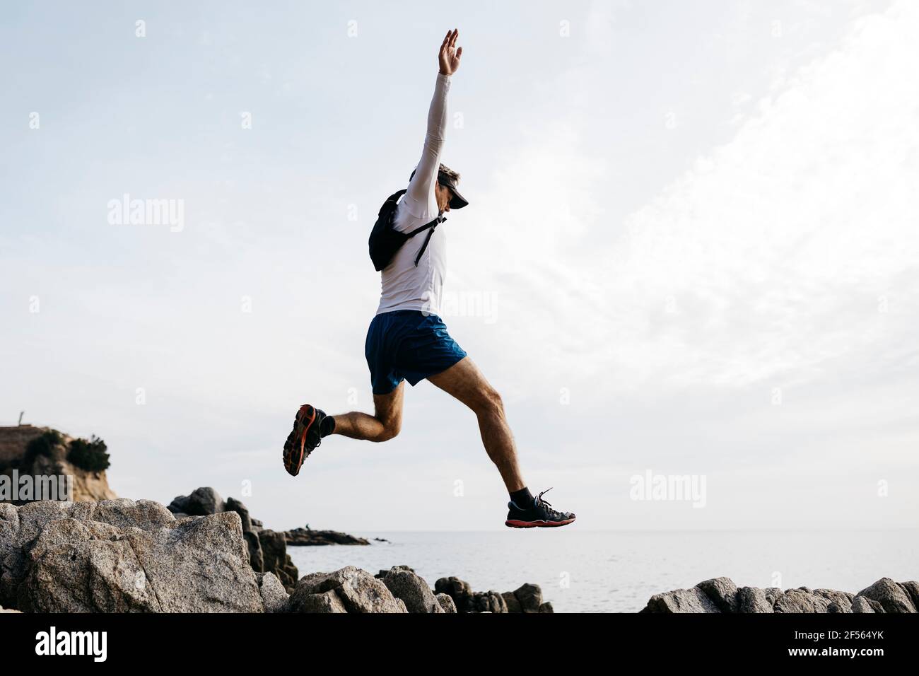Man jumping rock coast hi-res stock photography and images - Alamy