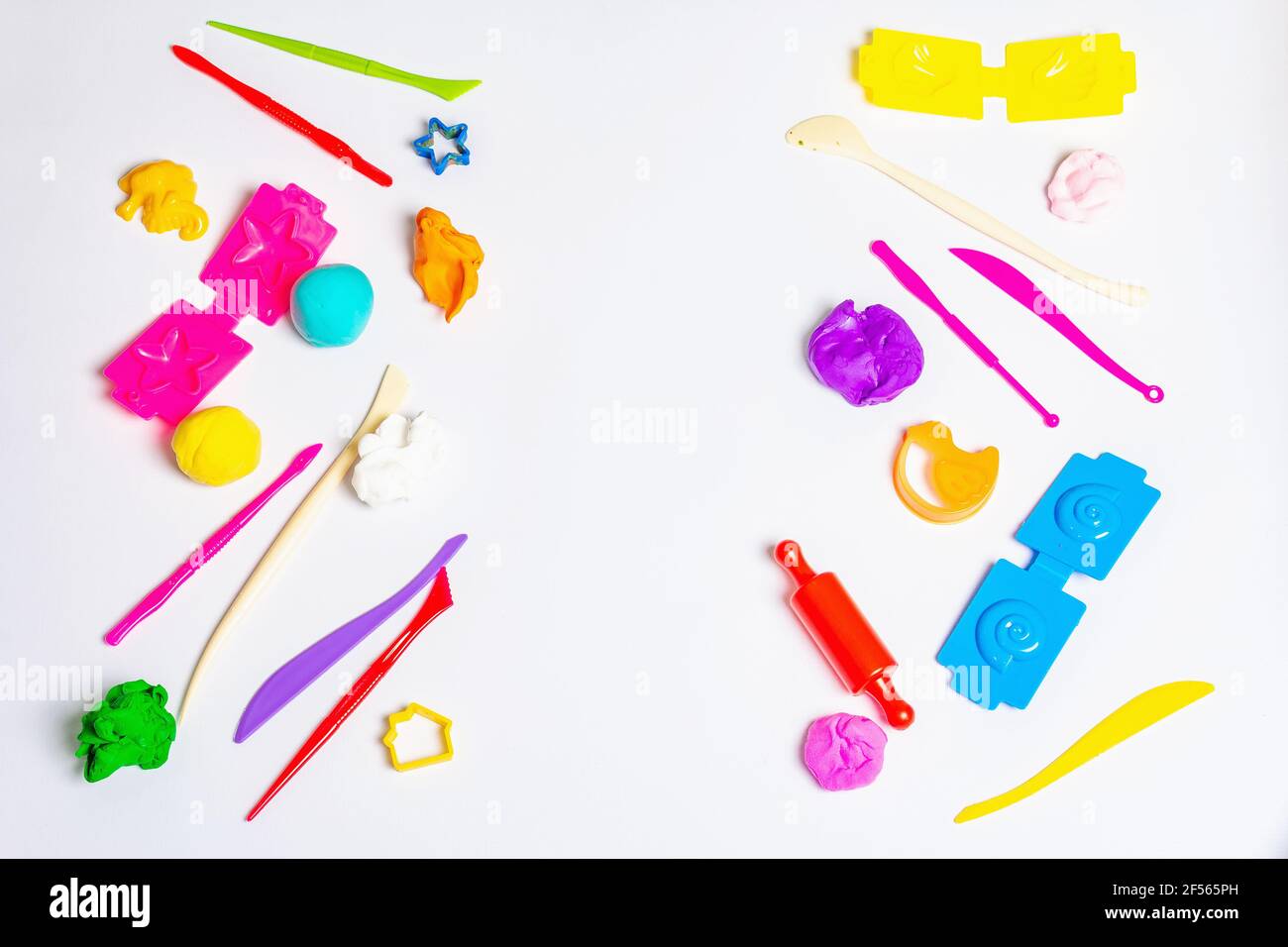 Colorful modeling clay, tools, and forms isolated on white background ...