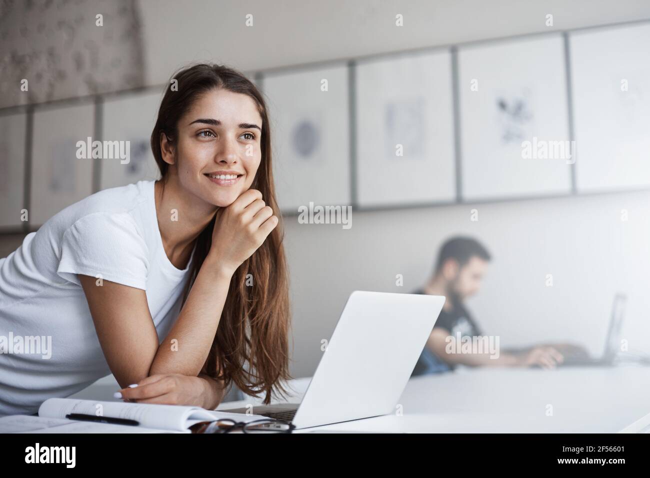 Young female university student using laptop computer to write a ...