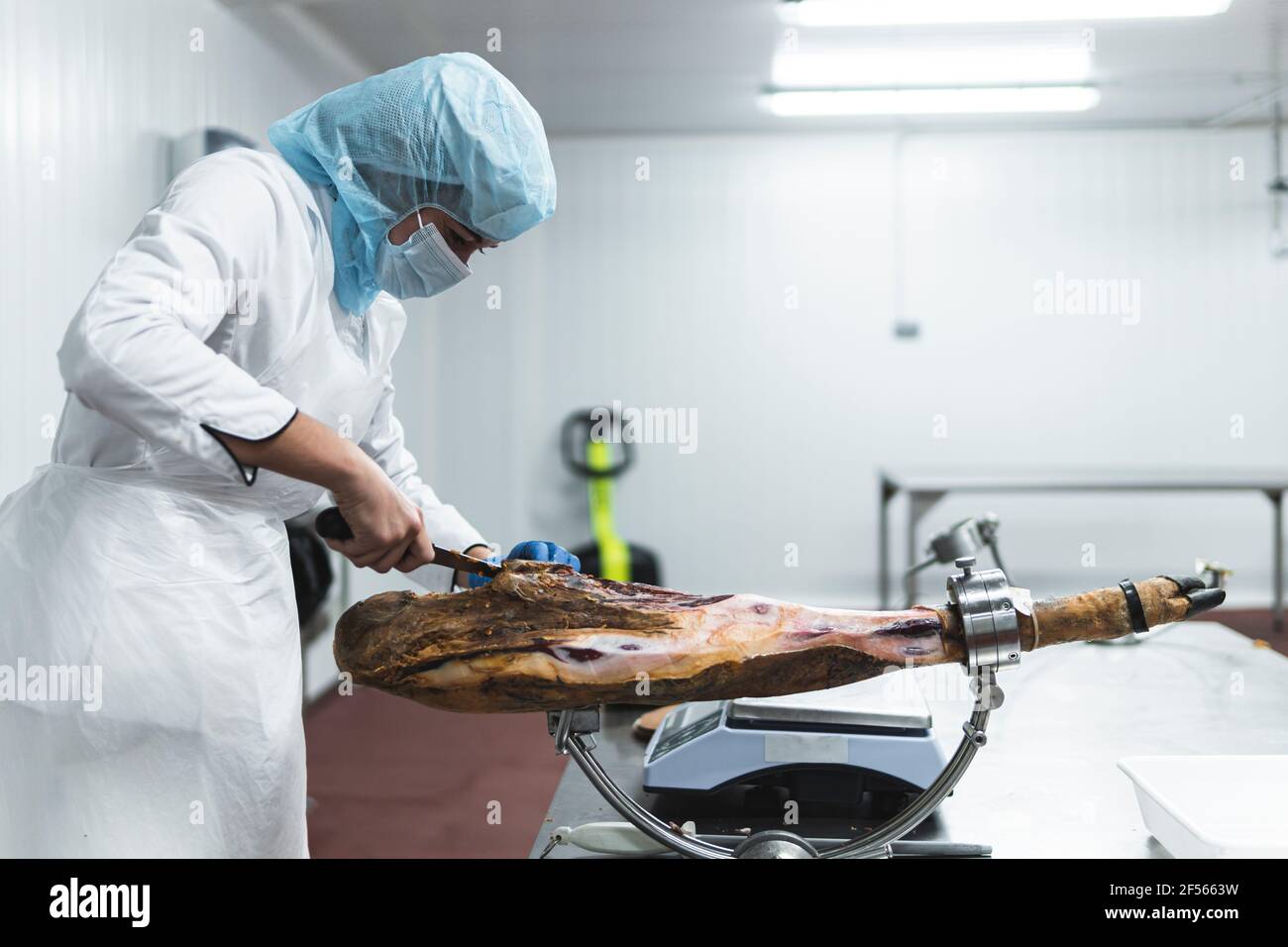 Woman cutting ham on hi-res stock photography and images - Alamy