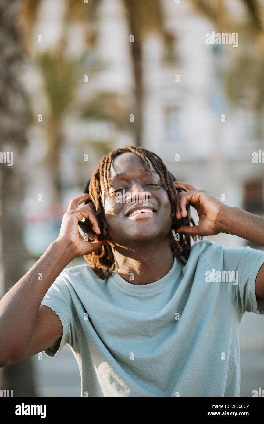 Happy african man listening hi-res stock photography and images - Alamy