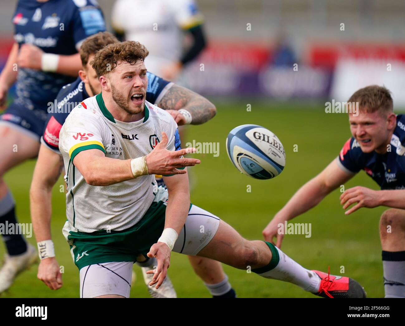 London Irish Centre Theo Brophy-Clews off loads as he breaks through ...