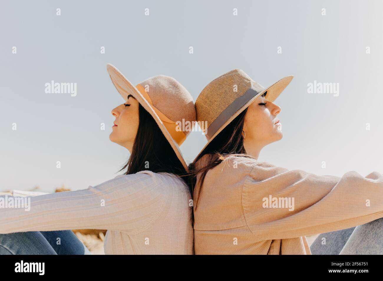 Twin sisters sitting outdoors hi-res stock photography and images - Alamy