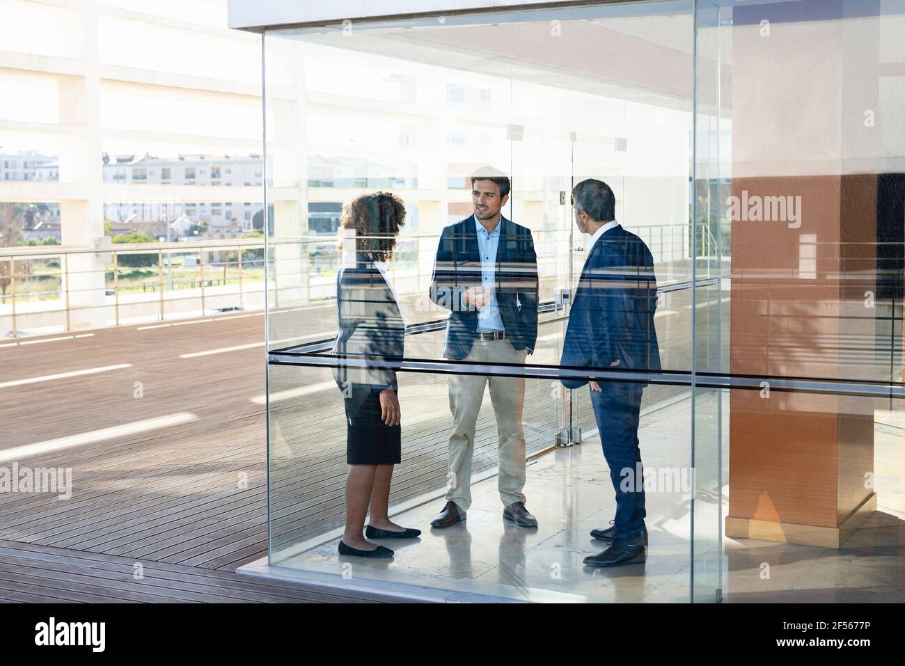 Expertise team having discussion while standing in modern office Stock ...