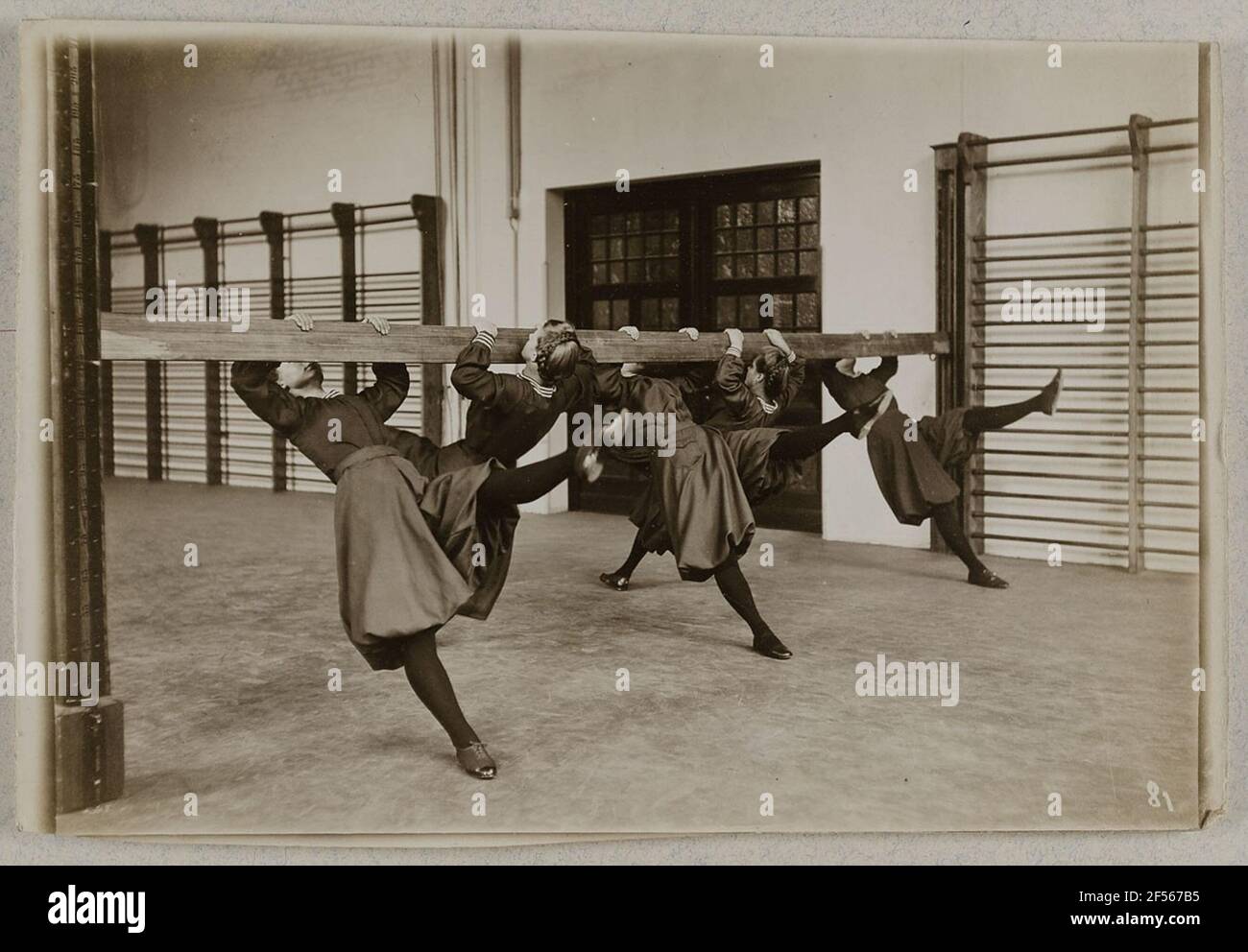 Exercises of the ladies at the beams Stock Photo - Alamy