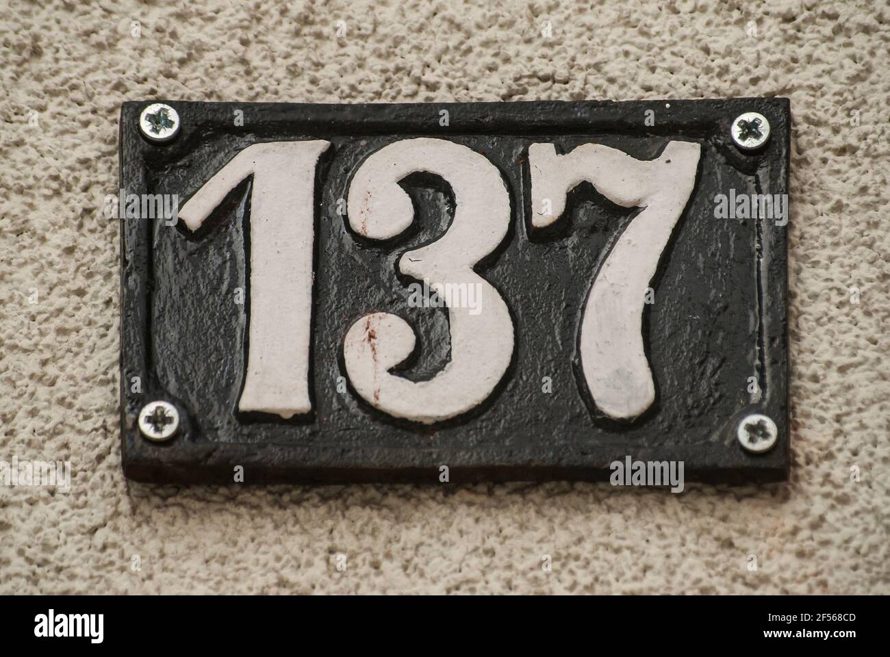 Old retro weathered cast iron plate with number 137 closeup Stock Photo ...