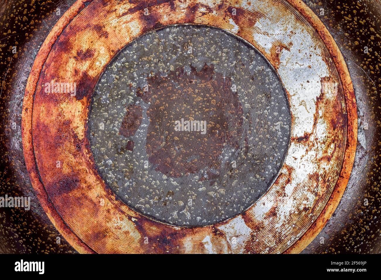frying pan bottom view of the burnt greasy surface of the coating of ...