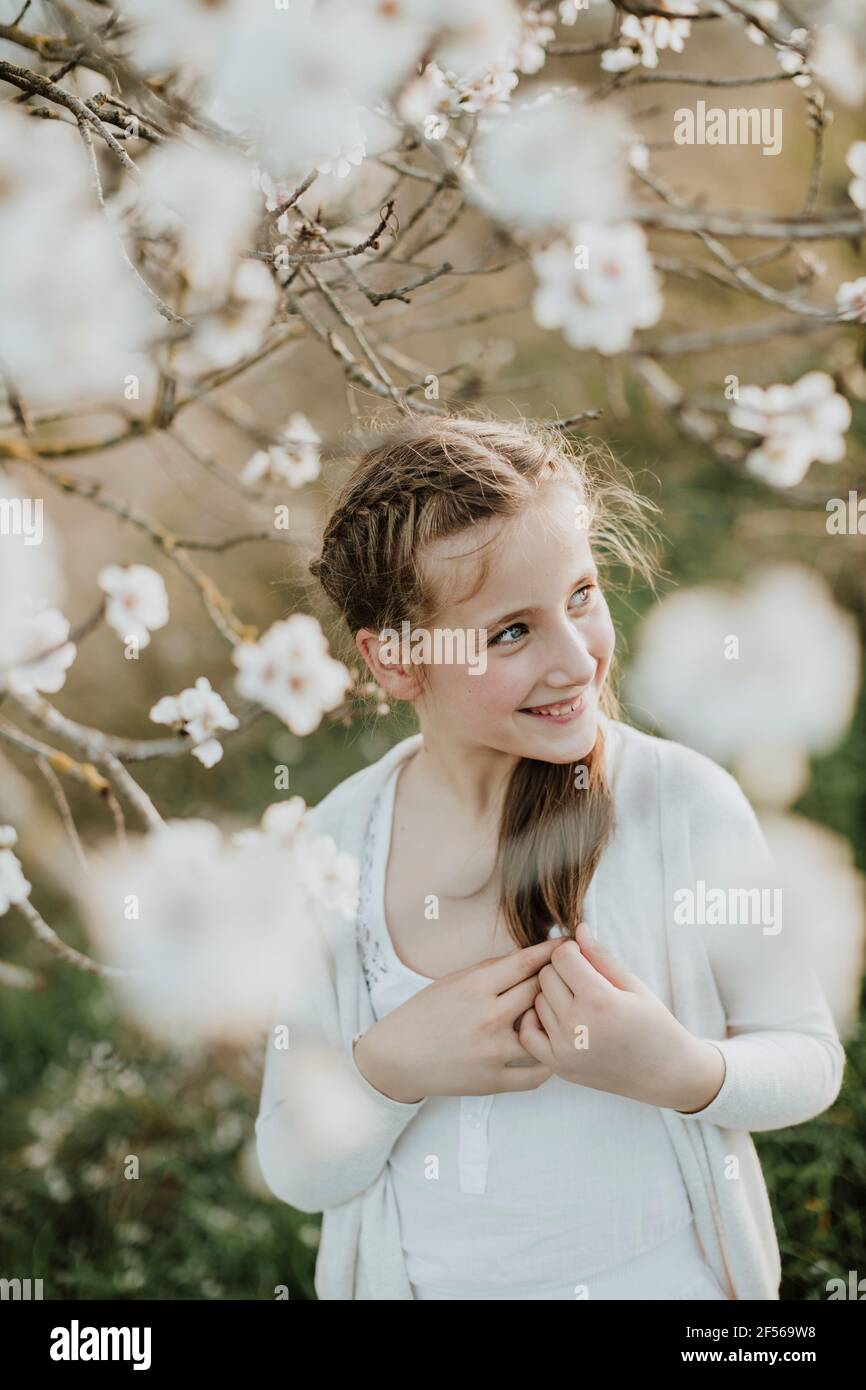 Girl branch flowering tree hi-res stock photography and images - Alamy