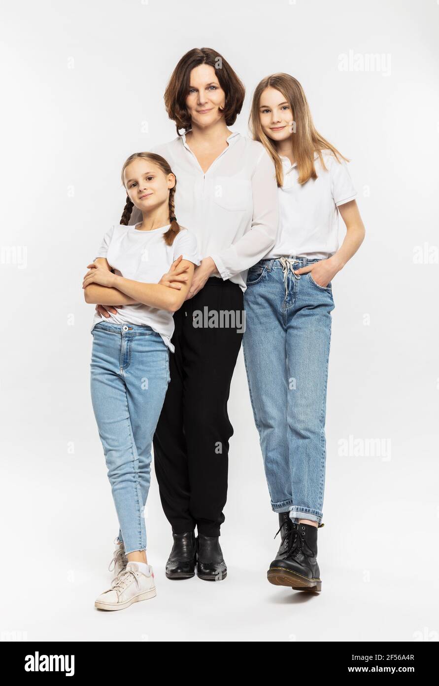Mother And Daughters Standing Together Against White Background Stock