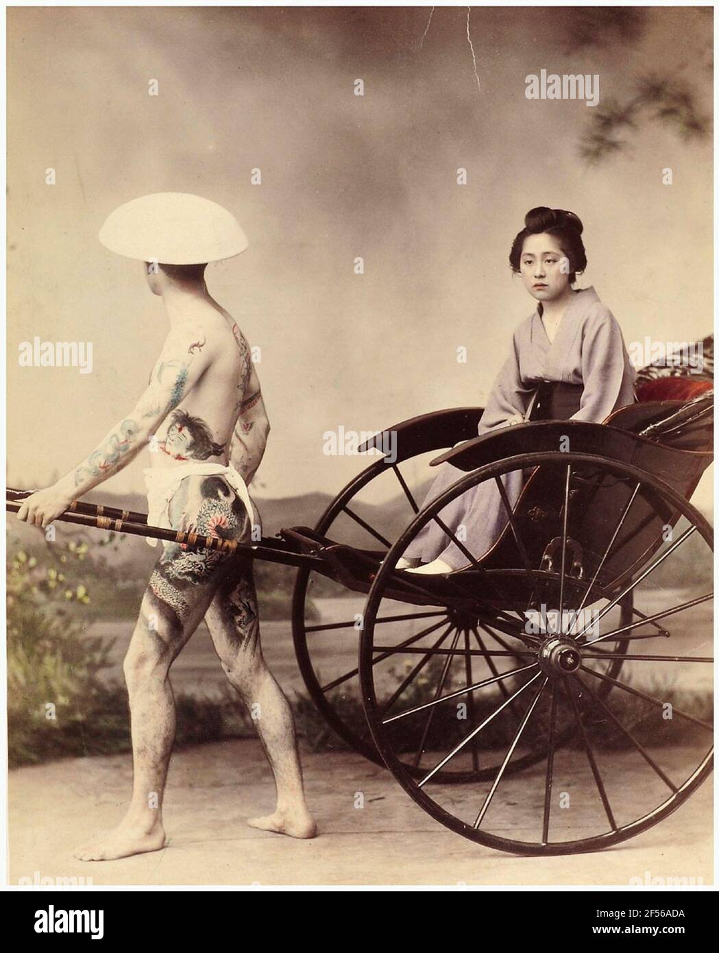 Tattooed man with geisha in Riksha Stock Photo - Alamy