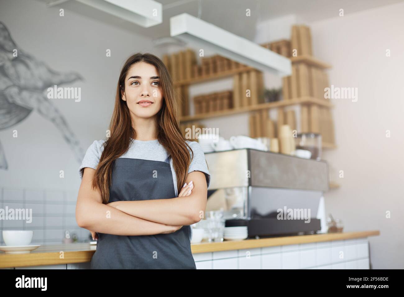 Portrait of confident woman cafe owner running successful business in ...