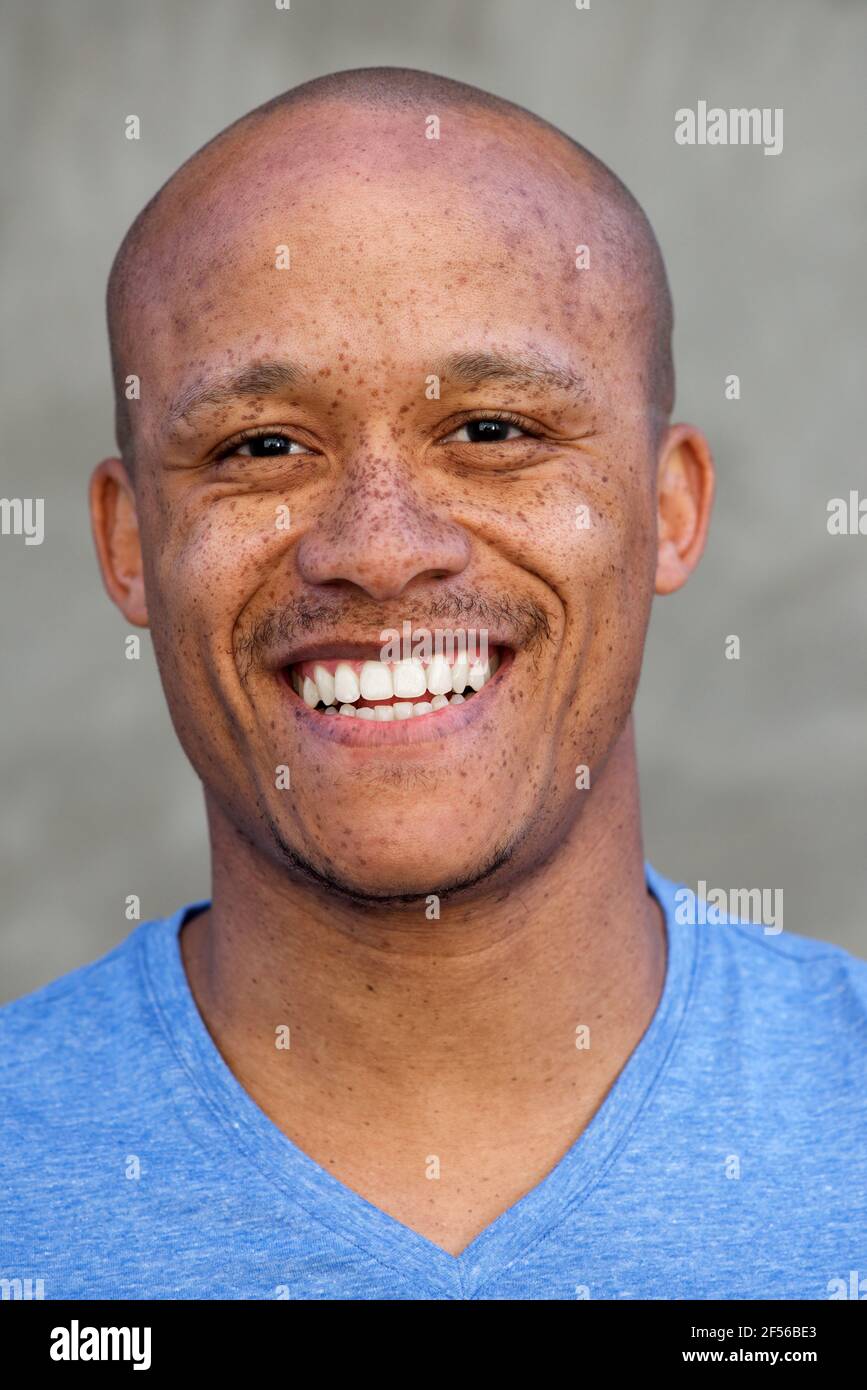 Close up portrait of handsome bald african man laughing Stock Photo - Alamy