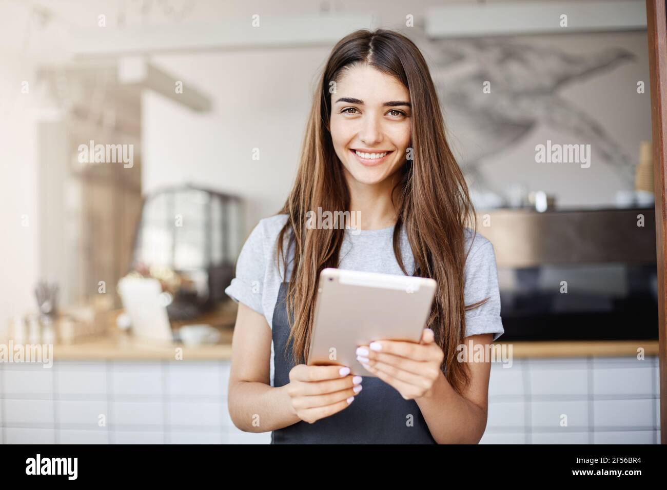 Woman at counter waiting for customers hi-res stock photography and ...