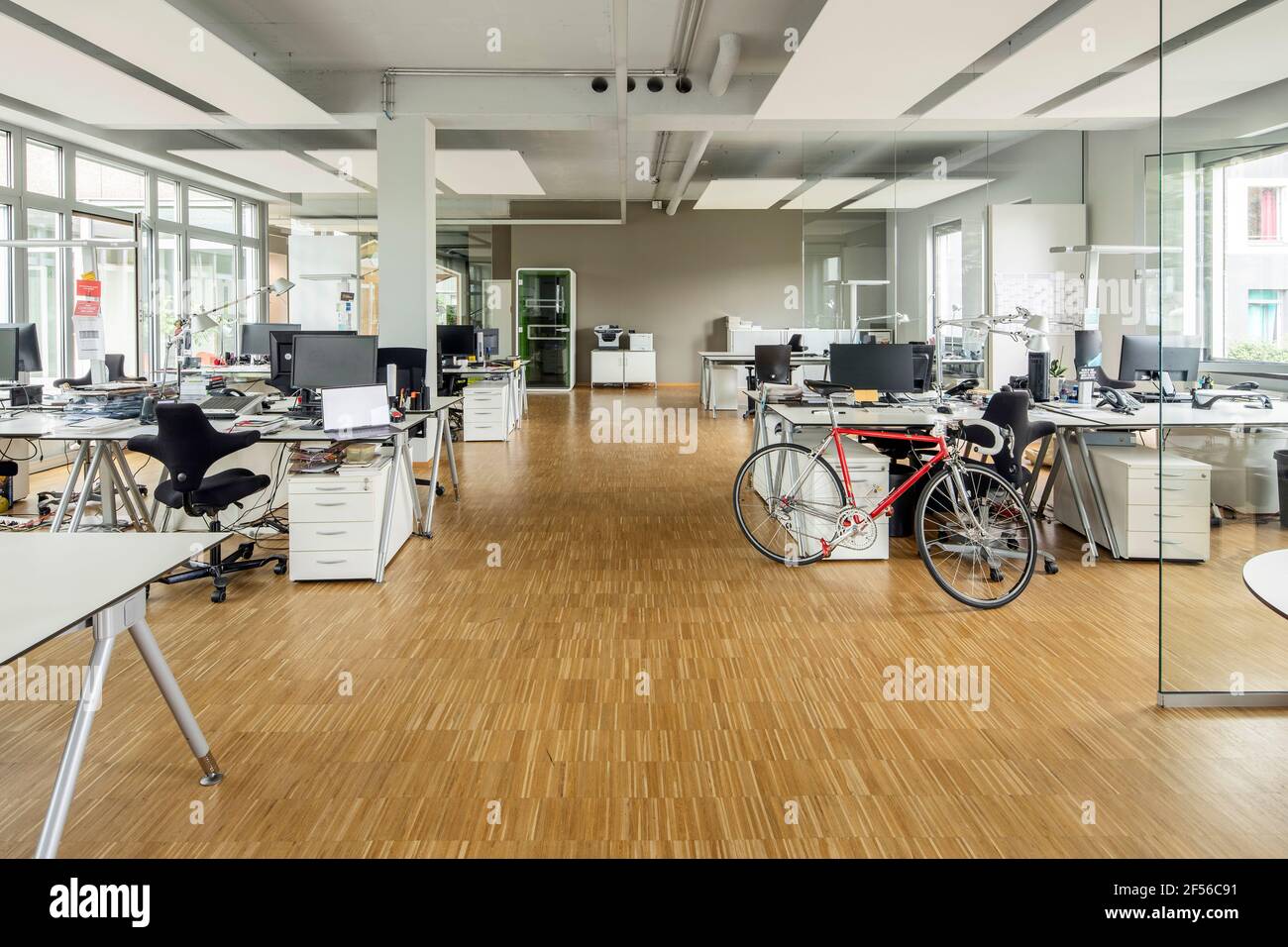 Bicycle at desk in office Stock Photo - Alamy
