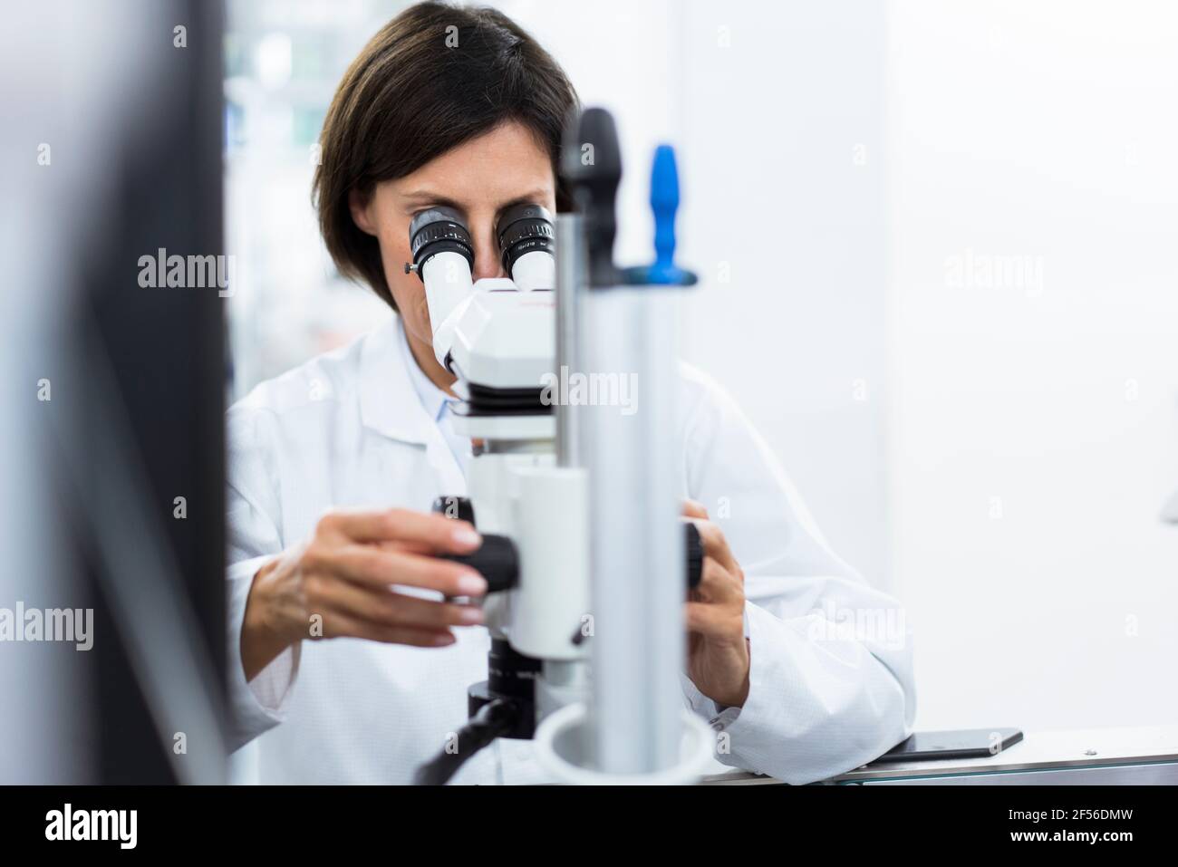 Female scientist using microscope at laboratory Stock Photo - Alamy