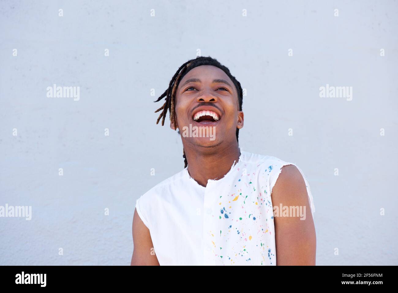 Portrait of african man with dreadlocks laughing and looking up Stock ...