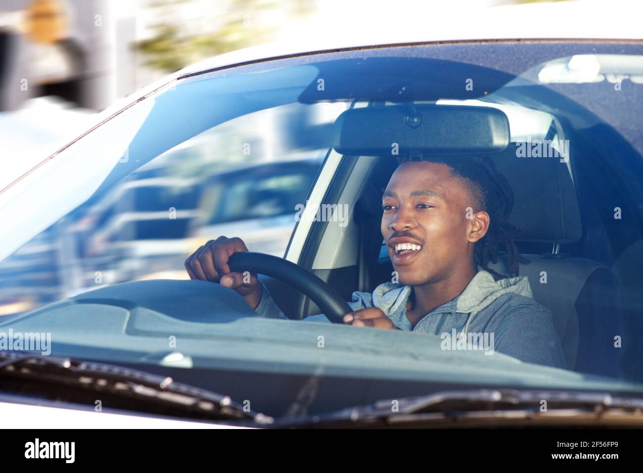 Portrait of smiling african man driving car in city Stock Photo - Alamy