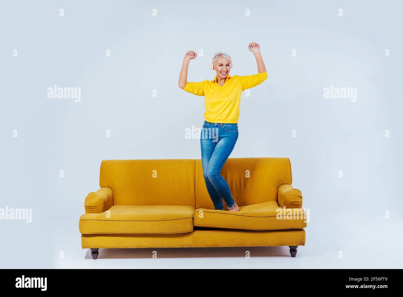 Woman dancing on couch hi-res stock photography and images - Alamy