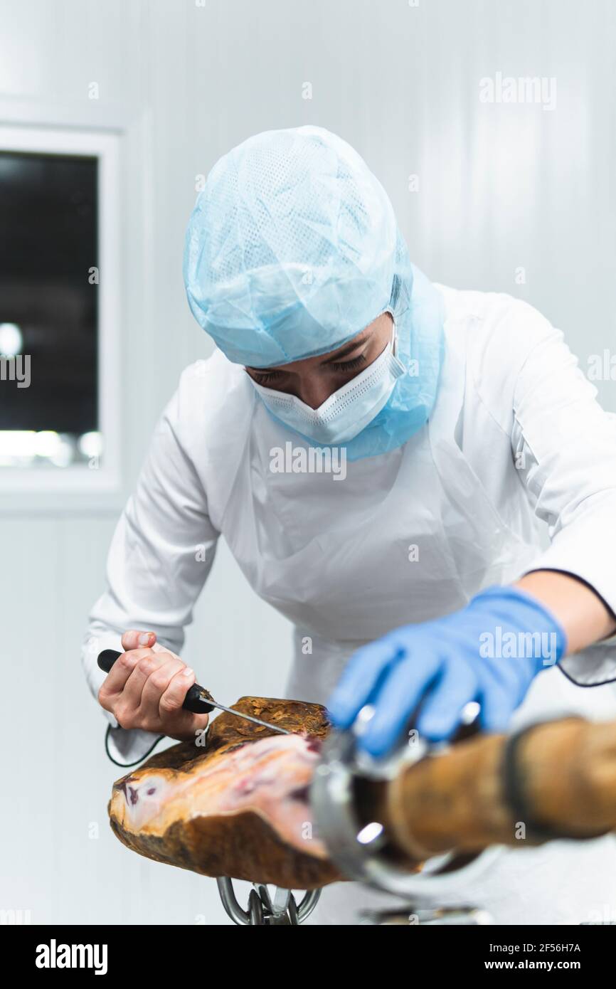 Female employee slicing ham in slaughterhouse Stock Photo - Alamy